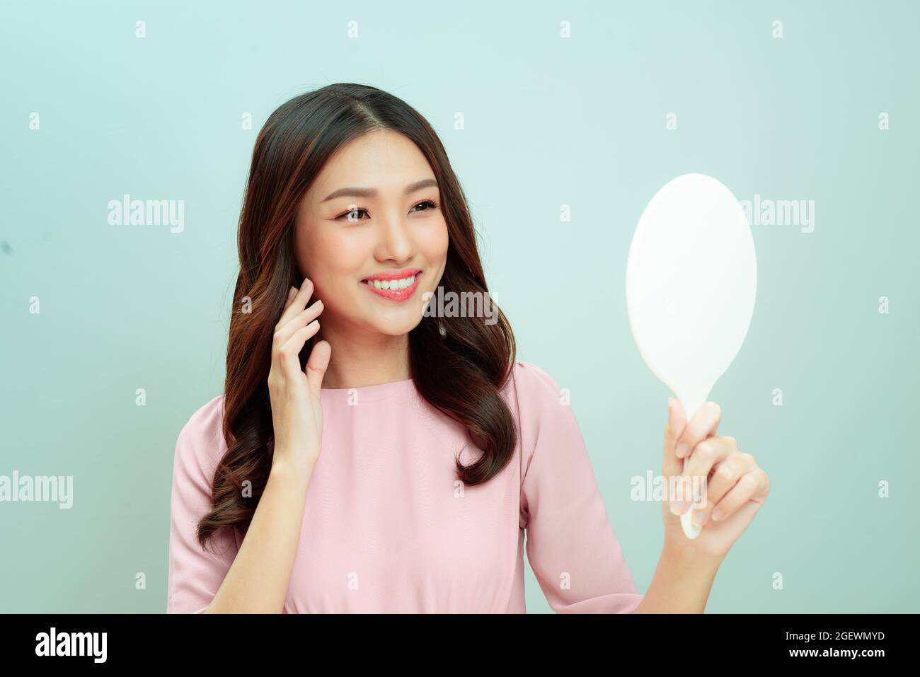 Woman caring of her beautiful skin and face by mirror at home, asian ...