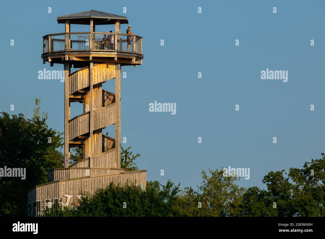 Tall metallic watchtower with people on it under the clear sky Stock ...