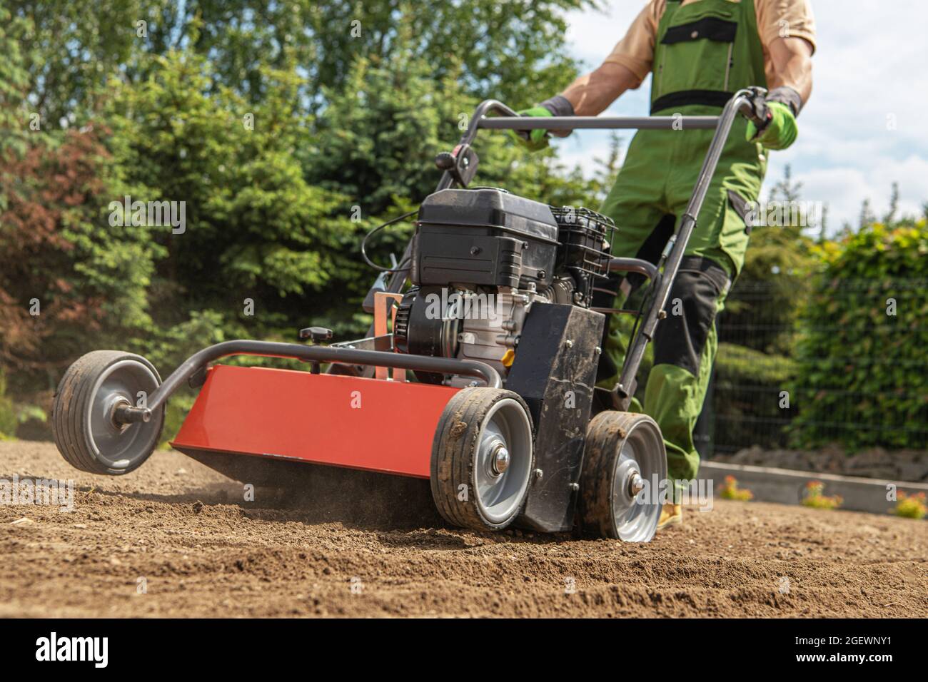 Gardener Pushing Gasoline Lawn Aerator and Preparing Soil For Nature ...