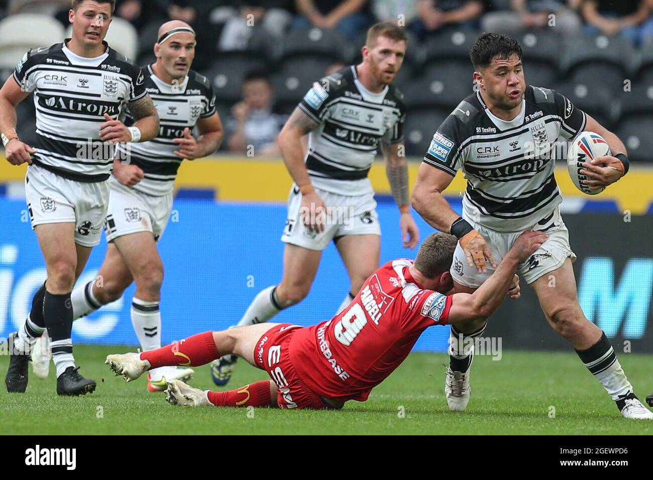 Andre Savelio (11) of Hull FC is tackled by Matt Parcell (9) of Hull KR ...