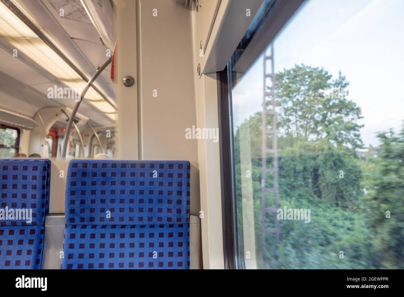 Interior view of a corridor inside passenger trains with blue fabric ...
