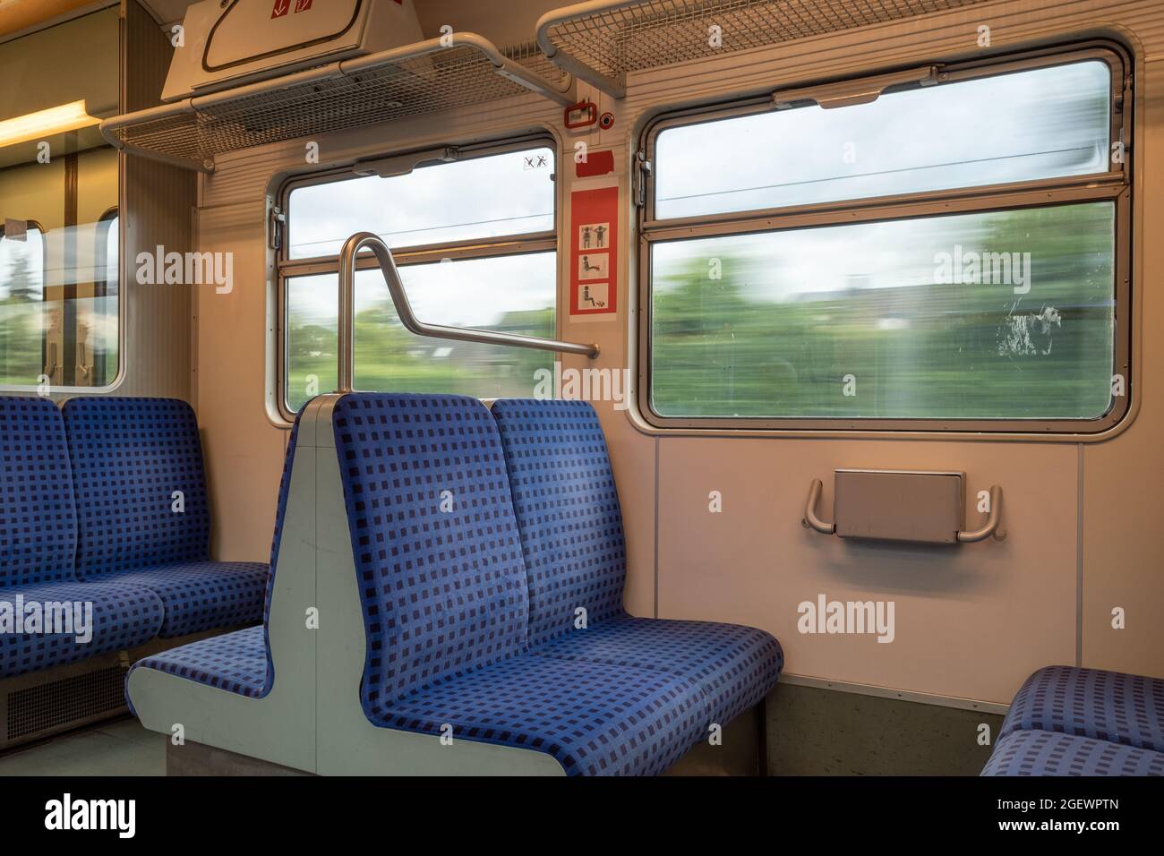 Interior view of a corridor inside passenger trains with blue fabric ...