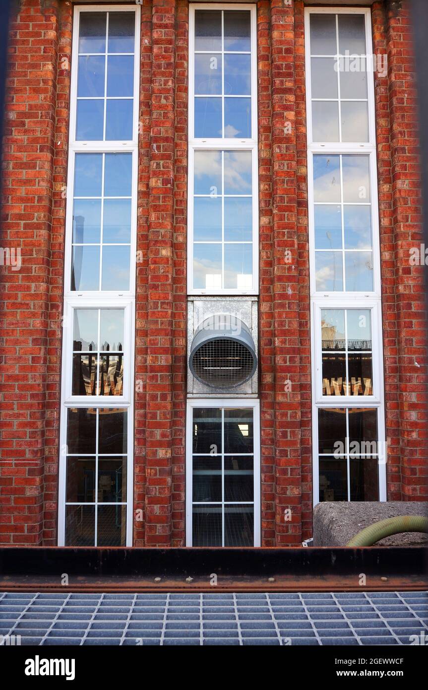 Reflections in windows of a 1940s industrial building or factory Stock ...