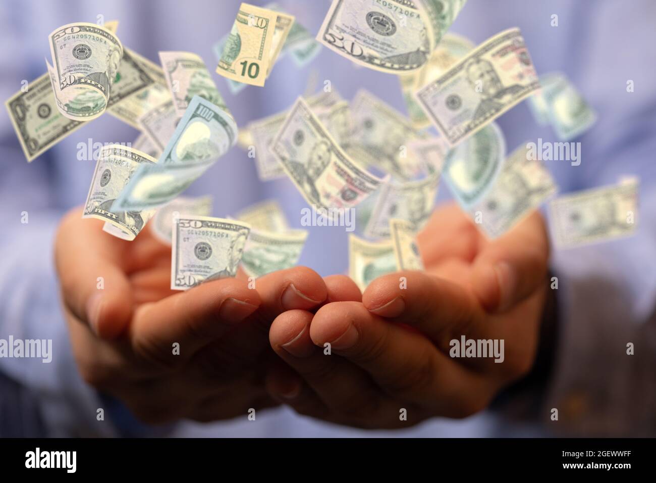 Flying euro banknote bills held in a person's hand Stock Photo - Alamy