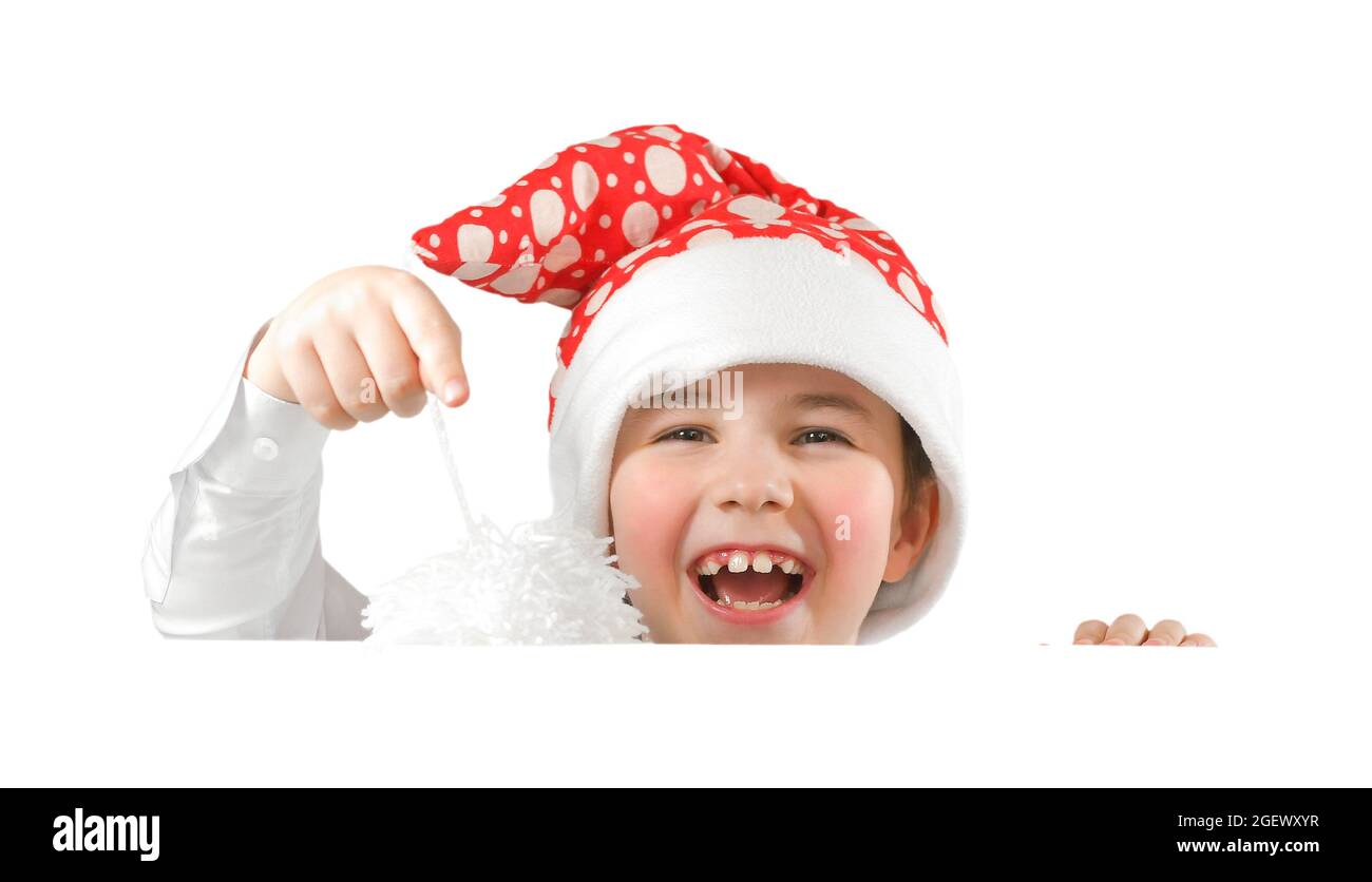 A child in a hat cap laughs merrily peeks out and points with a finger ...