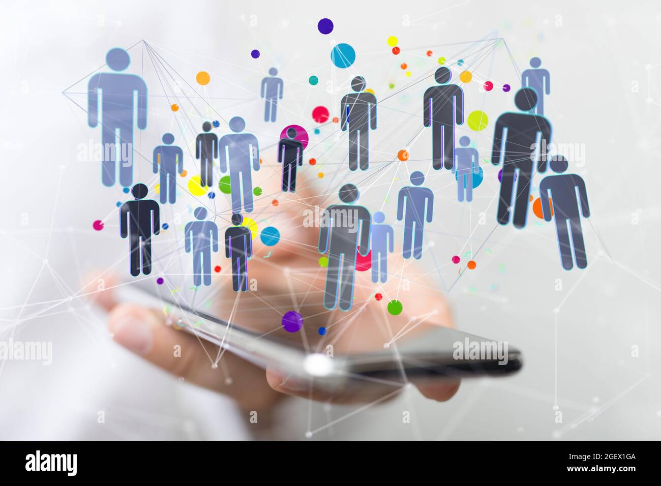 Person's hand holding a phone with 3D rendered people silhouettes in ...