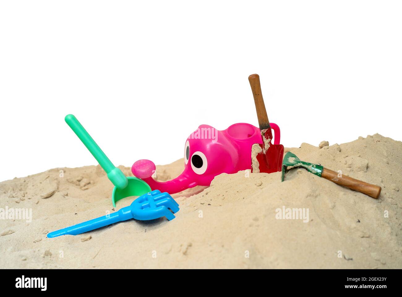 Closeup shot of beach toys on the sand isolated on a white background ...