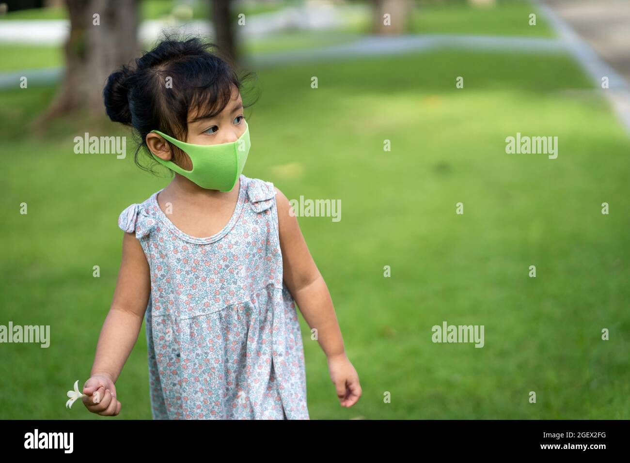 Little Thai girl wearing a protective face mask Stock Photo - Alamy