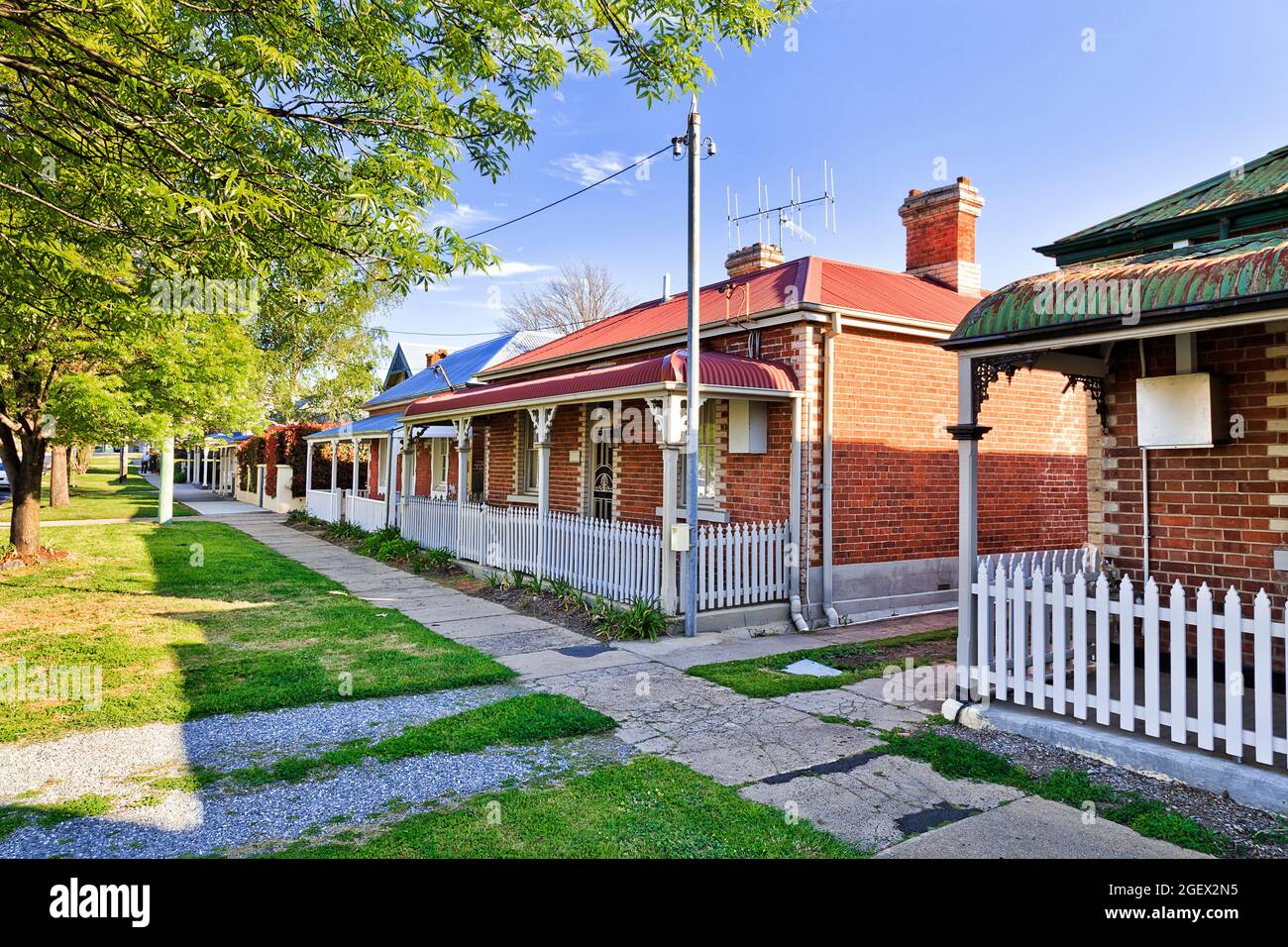 Calm green leafy street with historic characher houses in rural ...