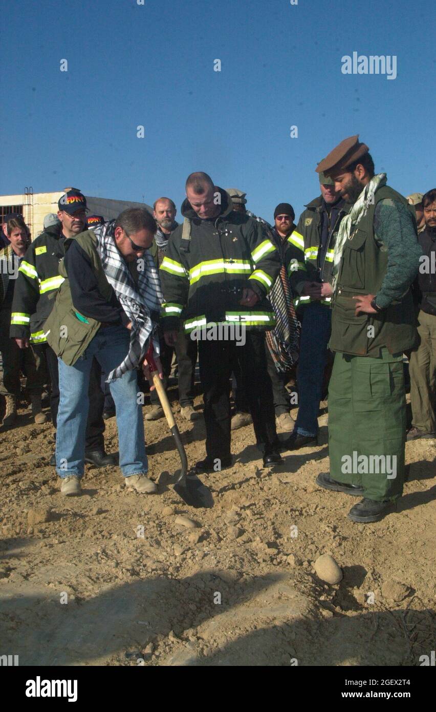 SOLDIERS DIG A HOLE TO BURY A PICE OF THE WORLD TRADE CENTER. PIECES OF ...