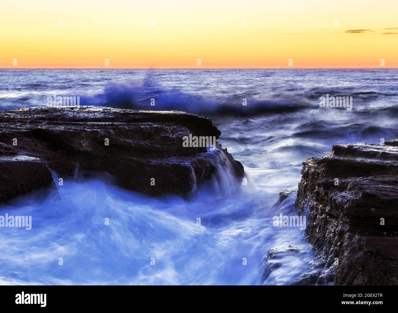 Dark wet rocks on Pacific coast of Sydney NOrthern beaches in scenic ...