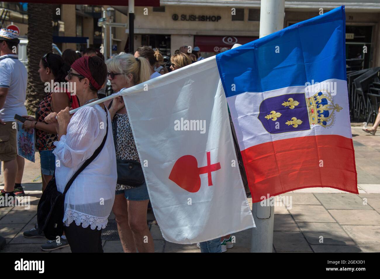 A woman holding flags referring to royalty and the Catholic heart of ...