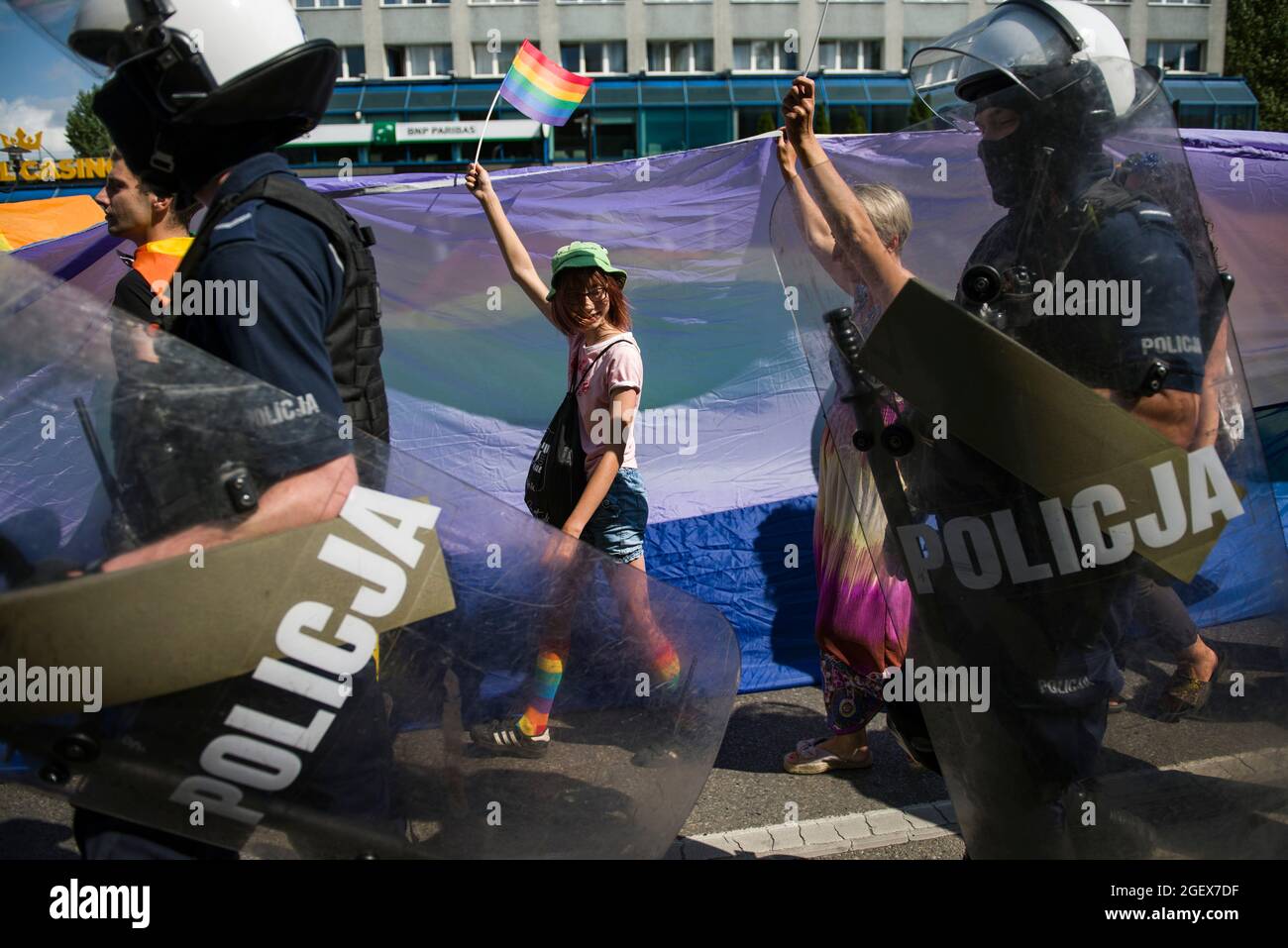 A participant waving a rainbow flag during the march.Hundreds of people ...