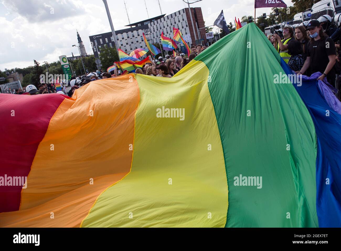 Participants holding a massive rainbow flag, during the march.Hundreds ...