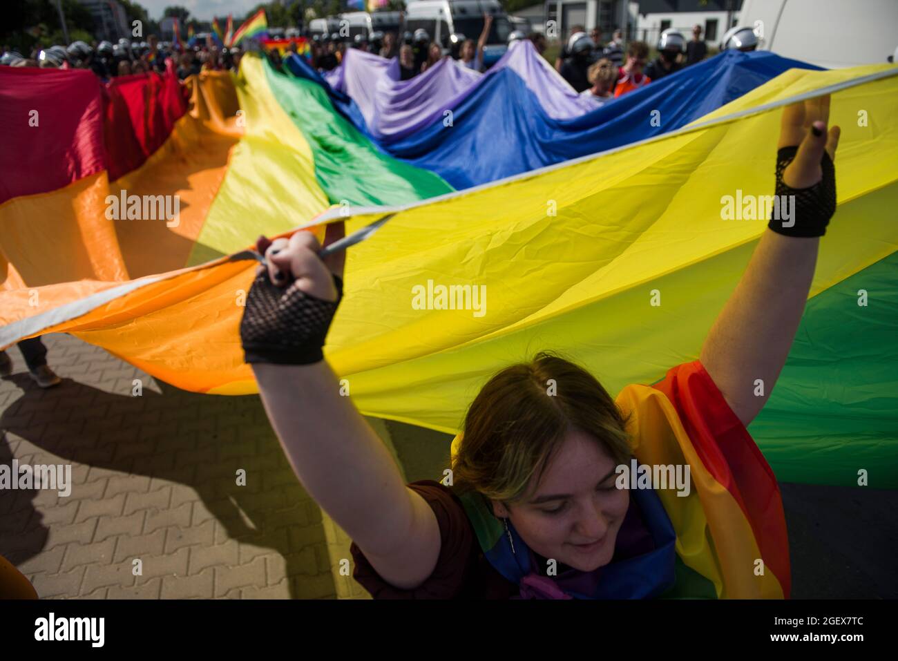 Participants holding a massive rainbow flag during the march.Hundreds ...