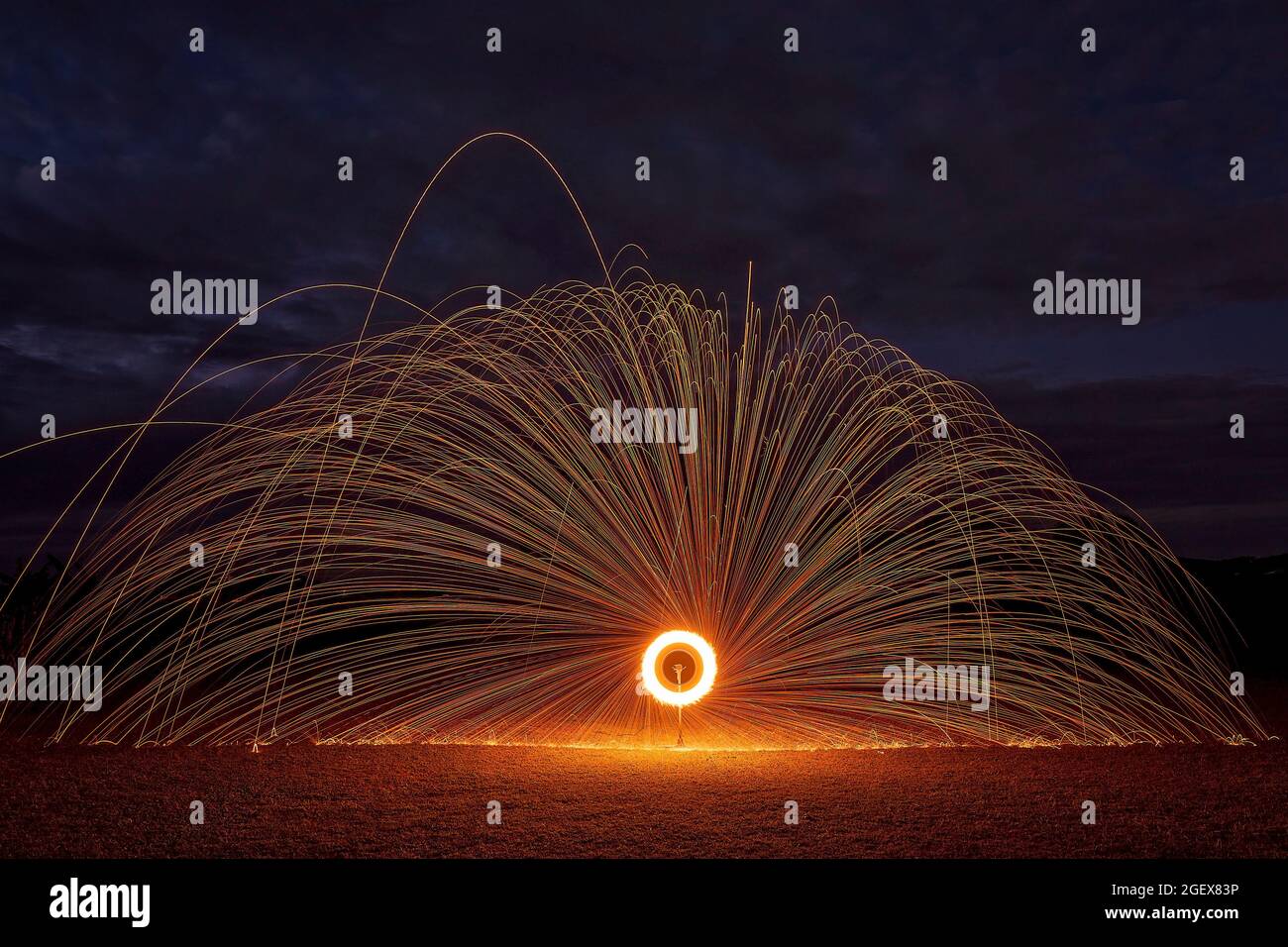A wheel of fire created using steel wool alight on a bicycle wheel at ...