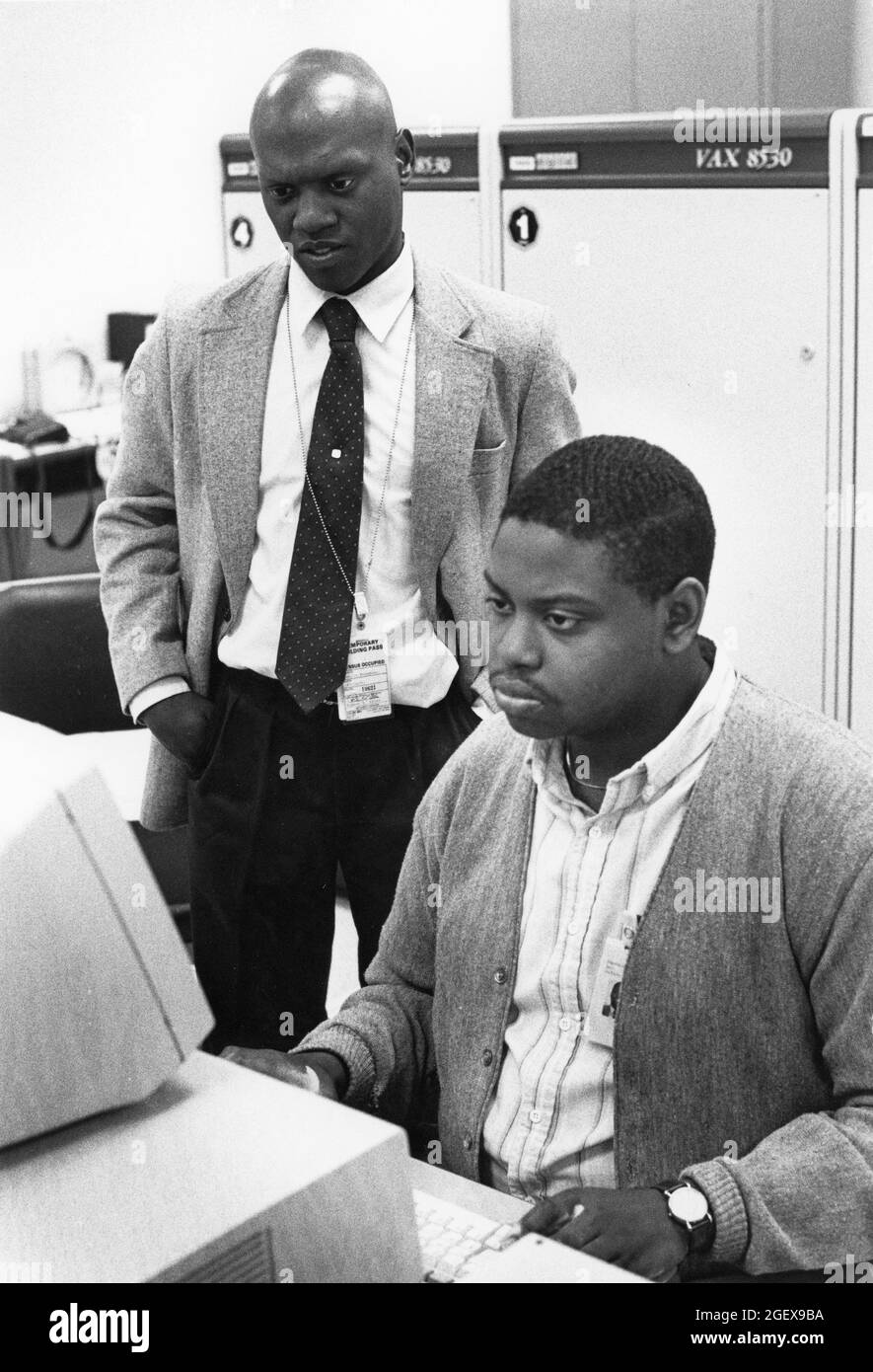 Austin Texas USA, 1990: Employee types data into computer terminal ...