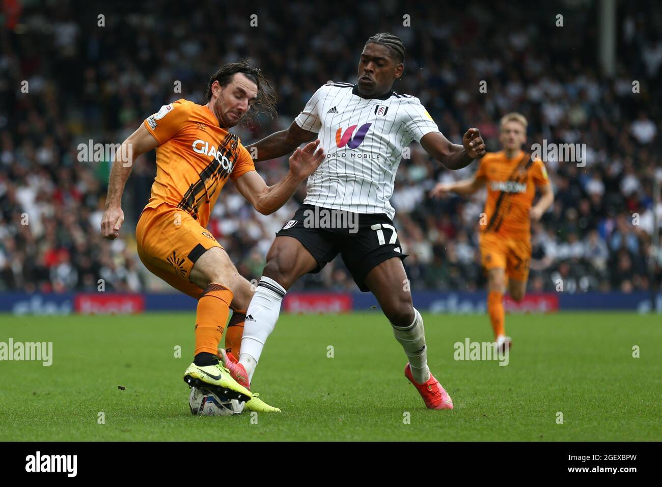 Lewis Coyle #2 of Hull City and #12 of Fulham battle for the ball Stock ...