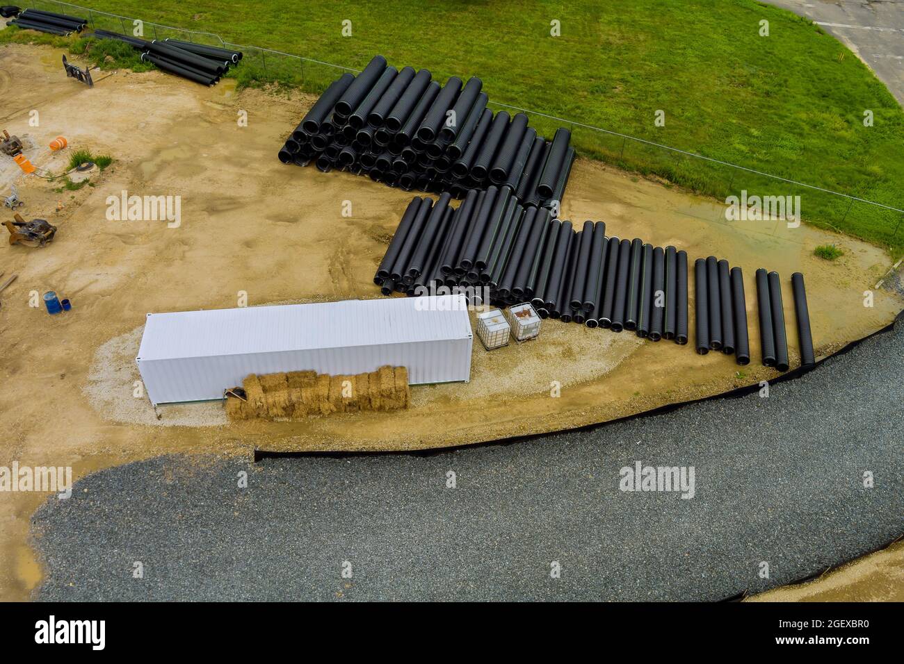 Plastic PVC pipes lying on the construction site ground on preparation ...
