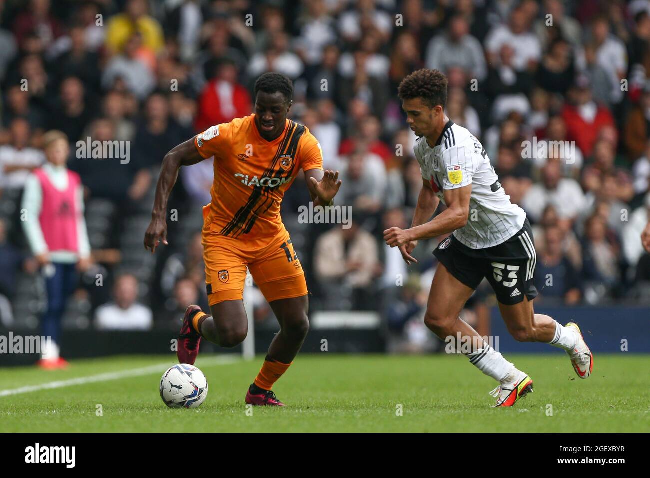 Josh Emmanuel #12 of Hull City under pressure from Antonee Robinson #33 ...