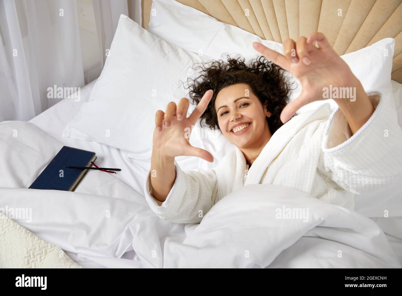 Smiling Woman Waking Up In Bed And Stretching Her Arms Up making ...