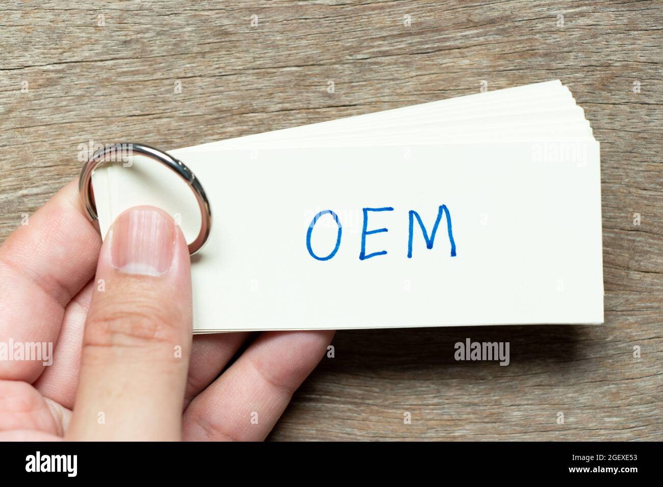 Man hold the flash card with handwriting word OEM (Abbreviation of ...