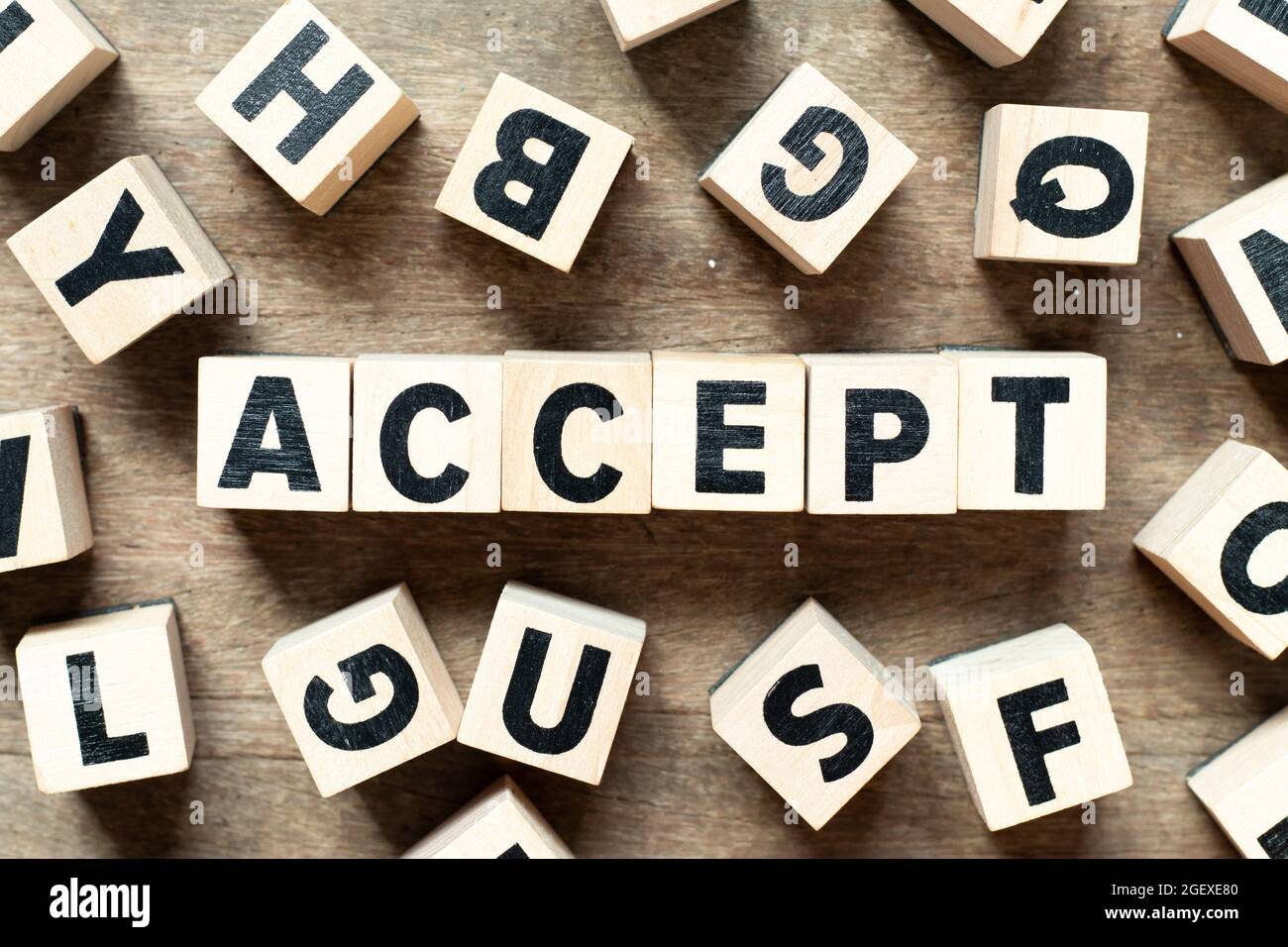 Alphabet letter block in word accept with another block on wood ...