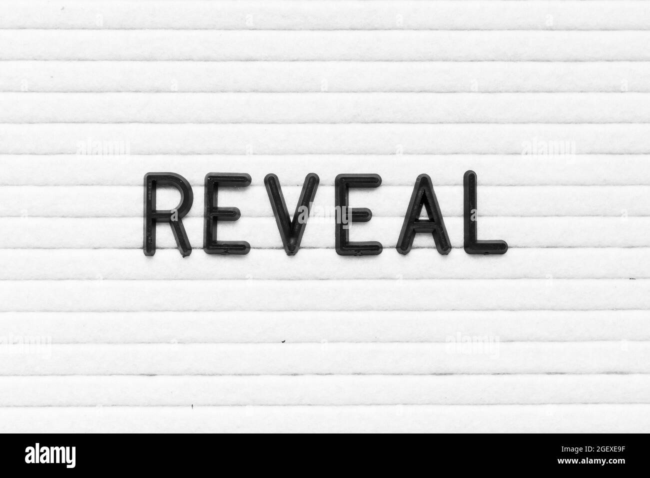 Black color letter in word reveal on white felt board background Stock ...