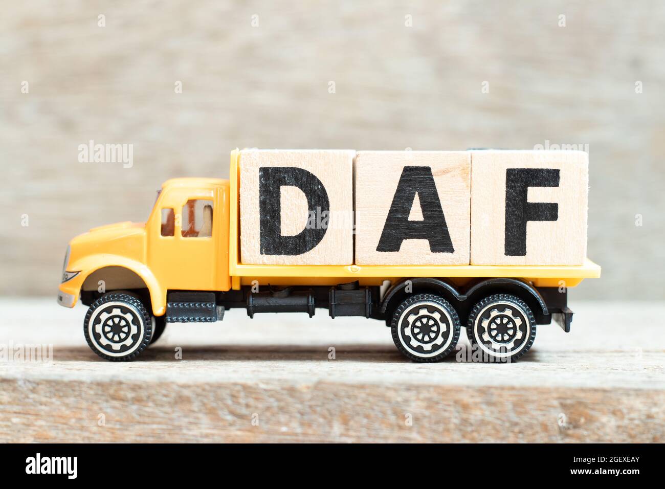 Toy truck hold alphabet letter block in word DAF (Abbreviation of ...
