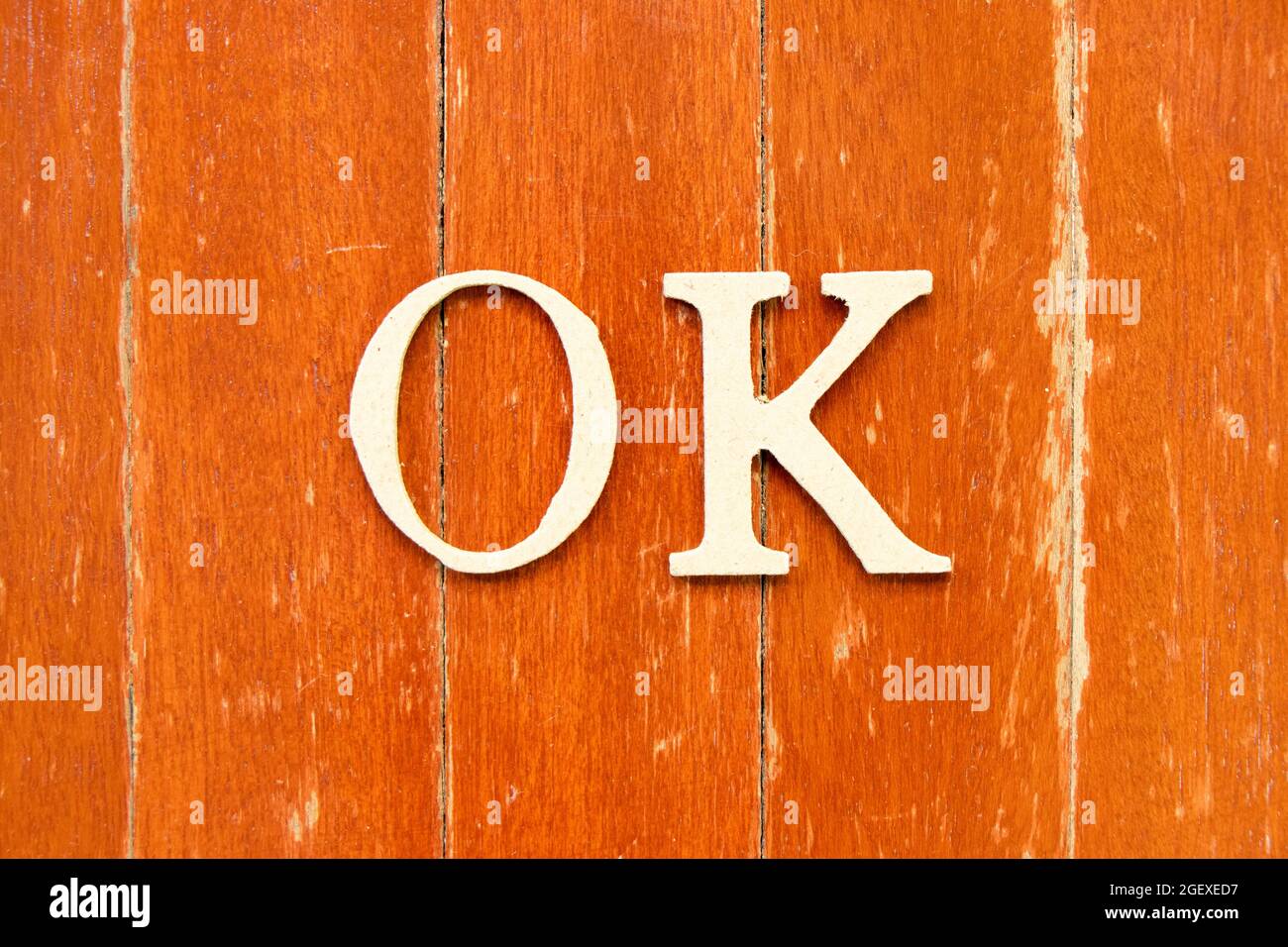 Alphabet letter in word ok on old red color wood plate background Stock ...