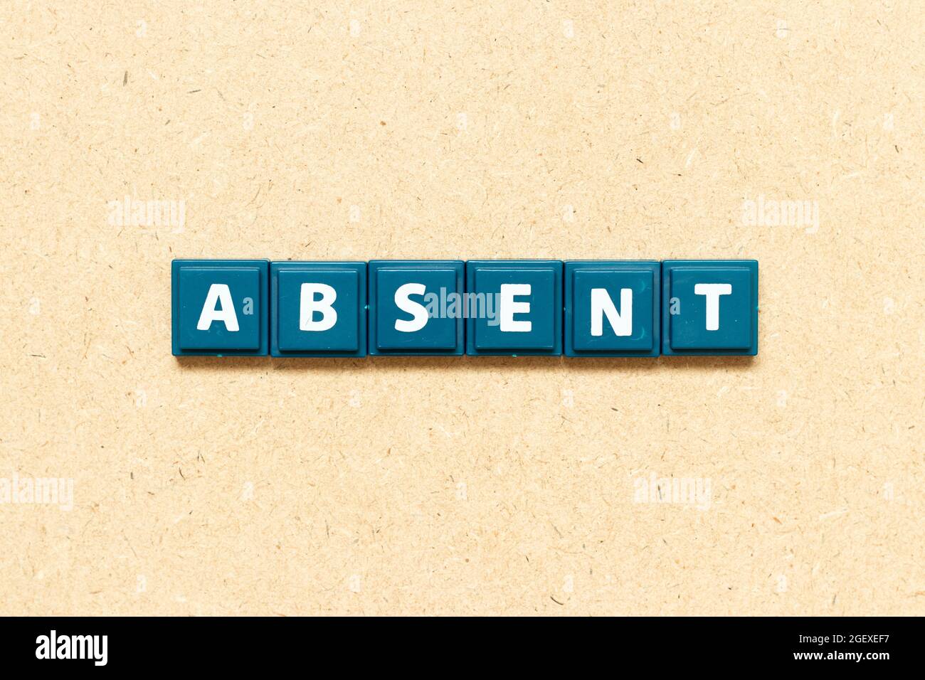 Tile alphabet letter in word absent on wood background Stock Photo - Alamy