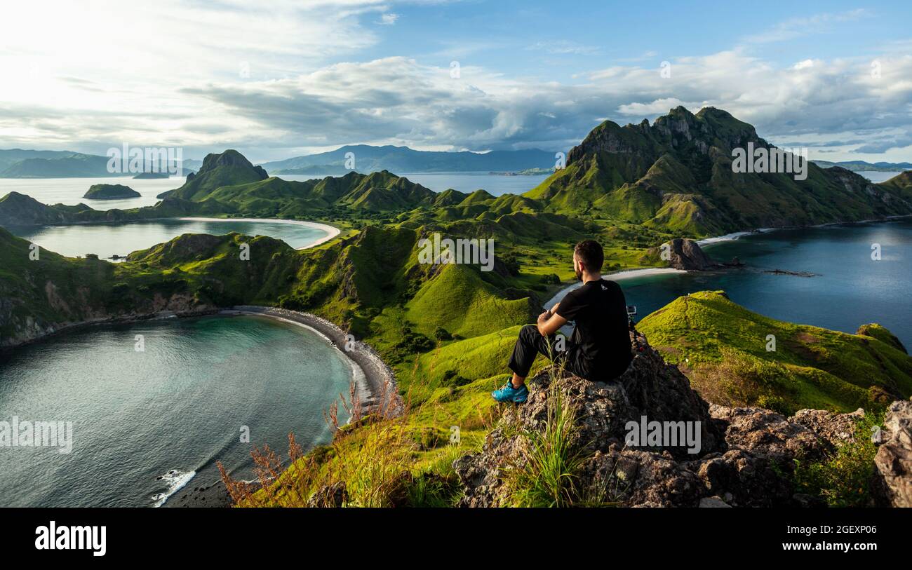 A man sitting on the rock on top of Padar island Stock Photo - Alamy