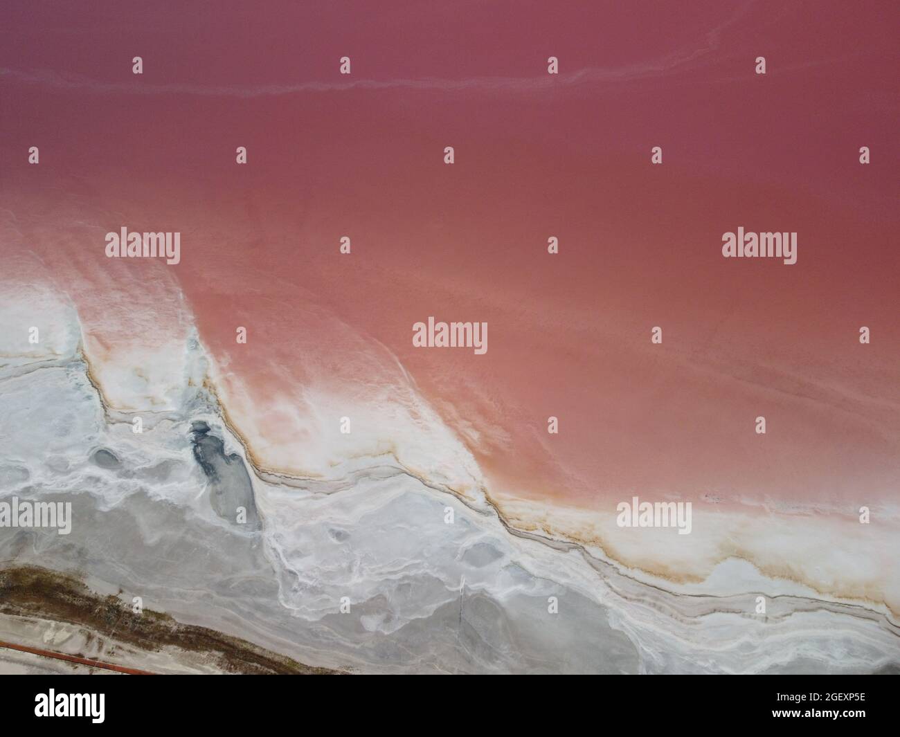 Flying over a pink salt lake. Salt production facilities saline ...