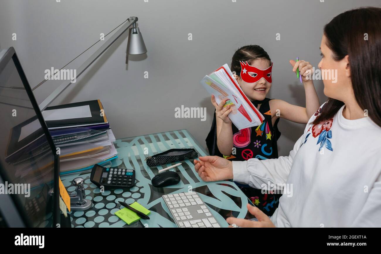 Woman working from home with her daughter interrupting her Stock Photo ...