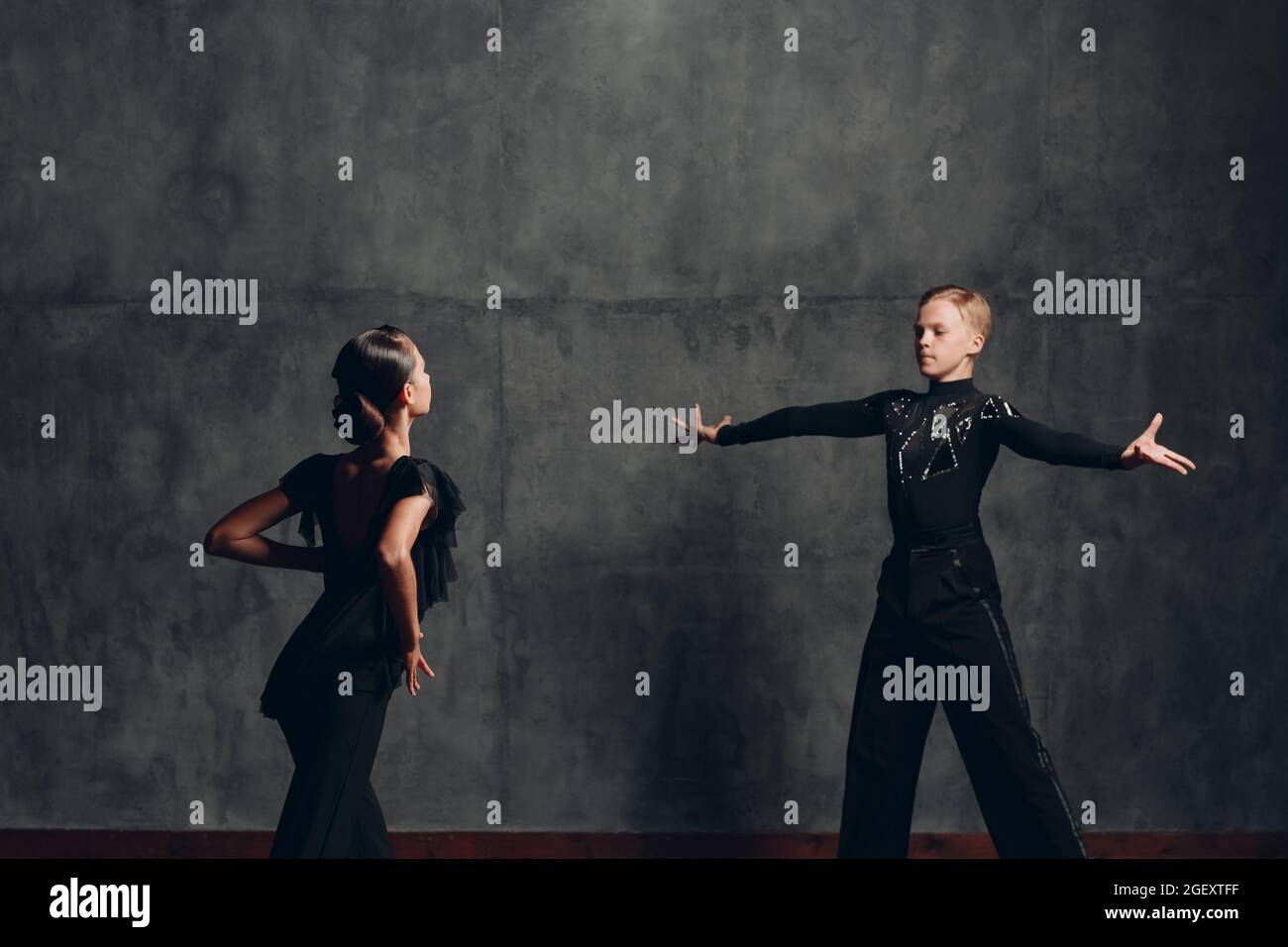 Couple in black costumes dancing in ballroom rumba dance Stock Photo ...