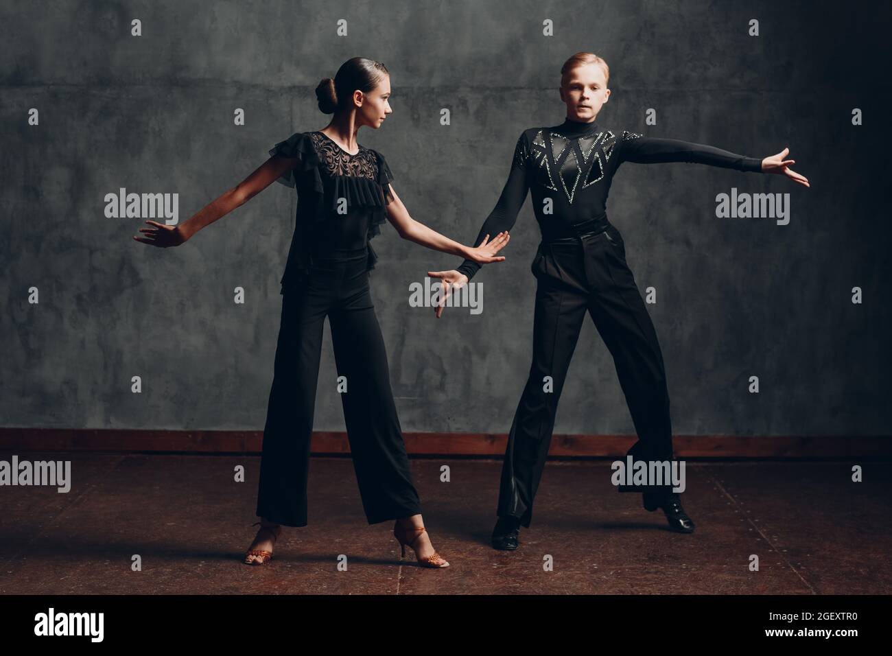 Young couple dancing in ballroom dance cha-cha-cha Stock Photo - Alamy