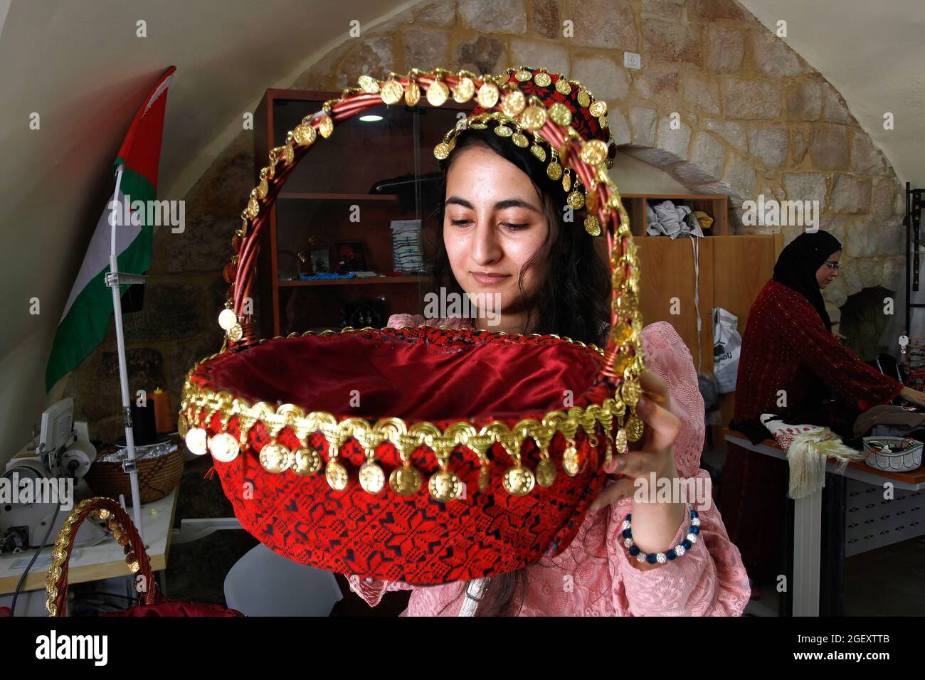 Nablus, Palestine. 21st Aug, 2021. A Palestinian attends an exhibition ...