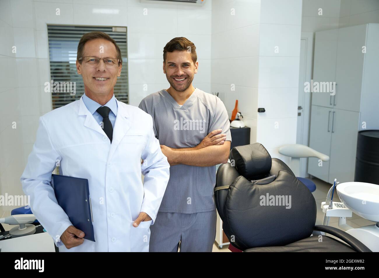 Friendly personnel of dental clinic looking welcome for patients Stock ...