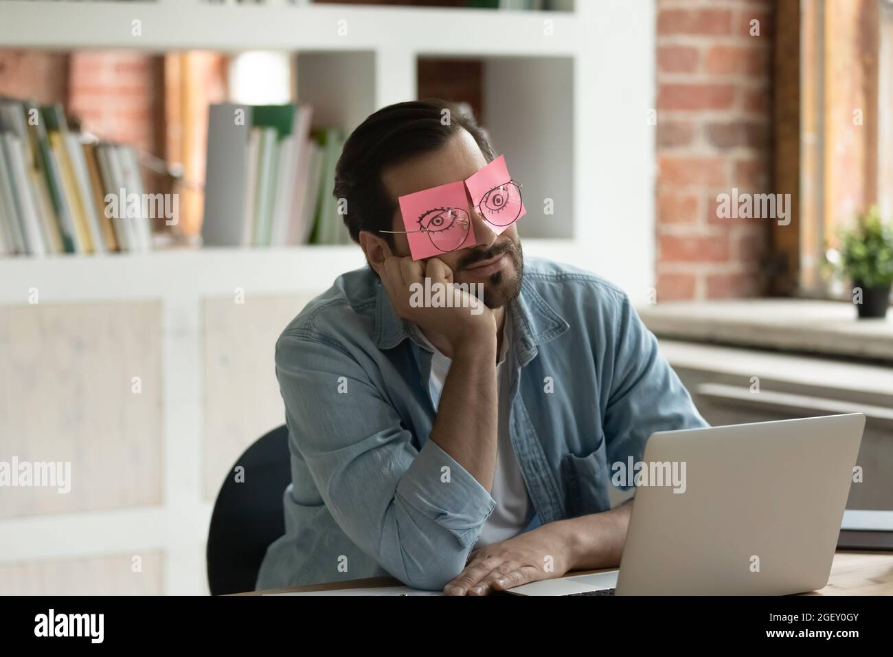 Sleeping employee hides eyes under sticky notes seated at desk Stock ... Sleeping employee hides eyes under sticky notes seated at desk Stock ...