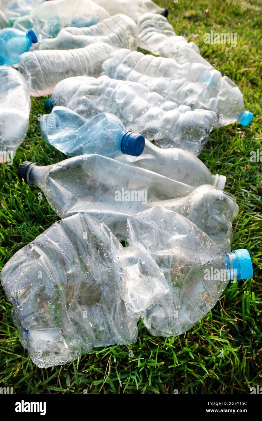Sign of incivility used plastic bottles abandoned in a meadow Stock ...