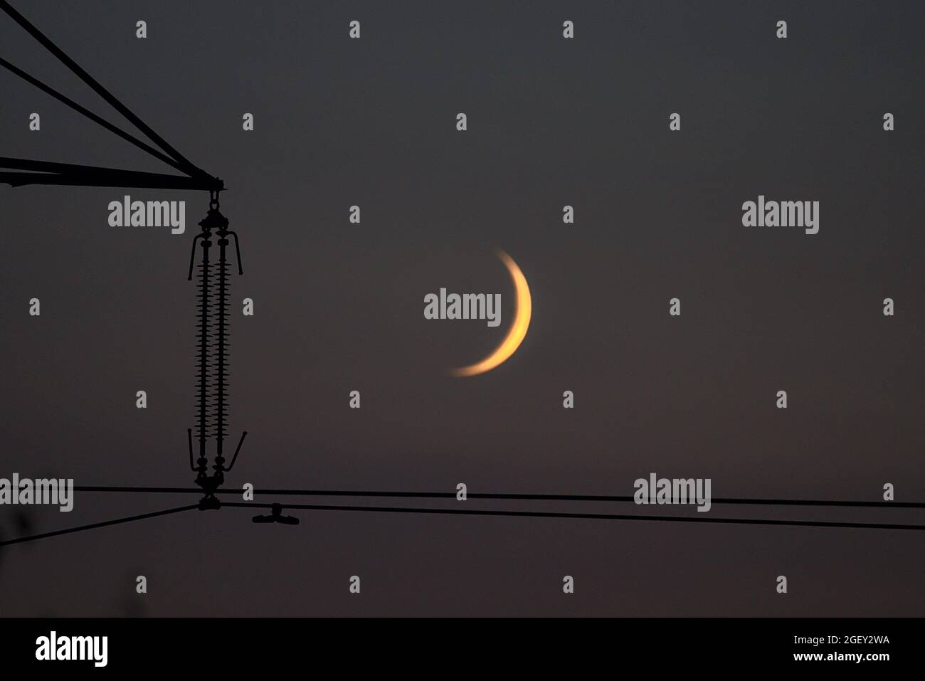 Beautiful evening view of crescent Moon near insulator of electricity ...