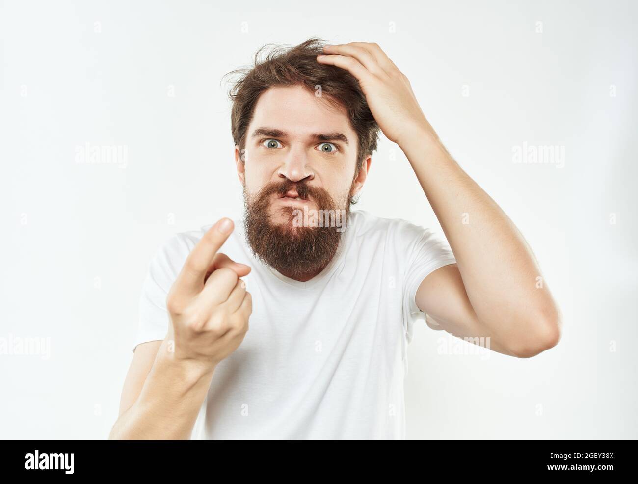emotional man in a white t-shirt hand gestures anger light background ...