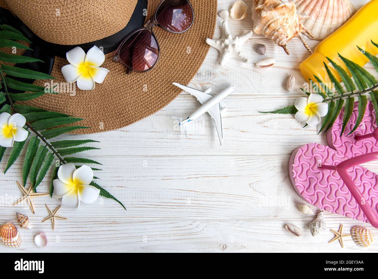 Summer vacation concept. Straw hat and beach accessories with seashells ...