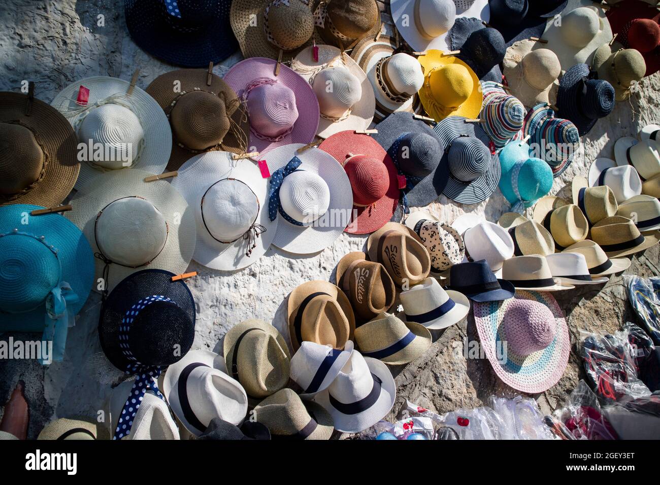 Display of a series of hats hanging from a wall in the street Stock ...