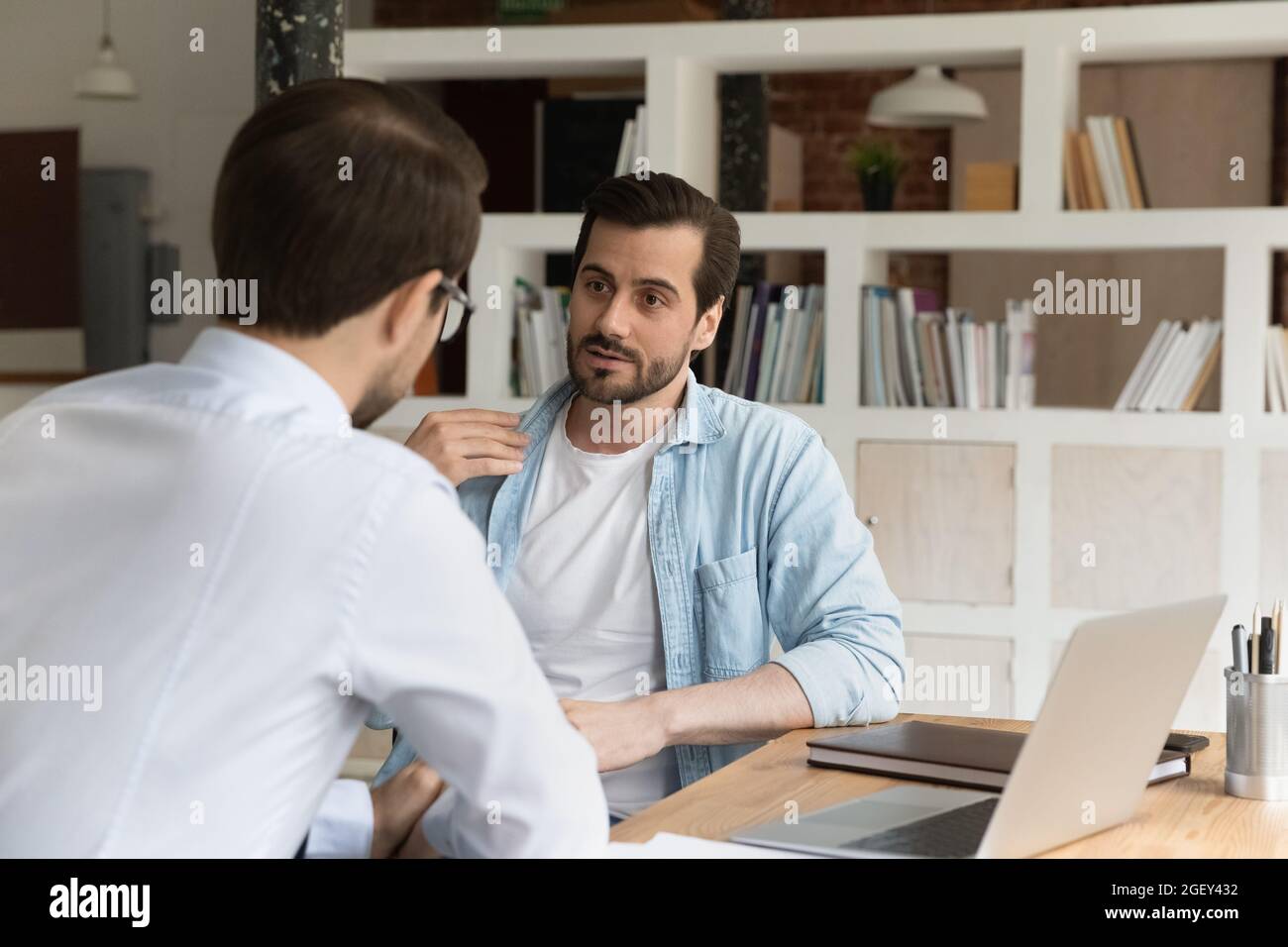 Businesspeople male staff members talking sit at workplace desk Stock ...