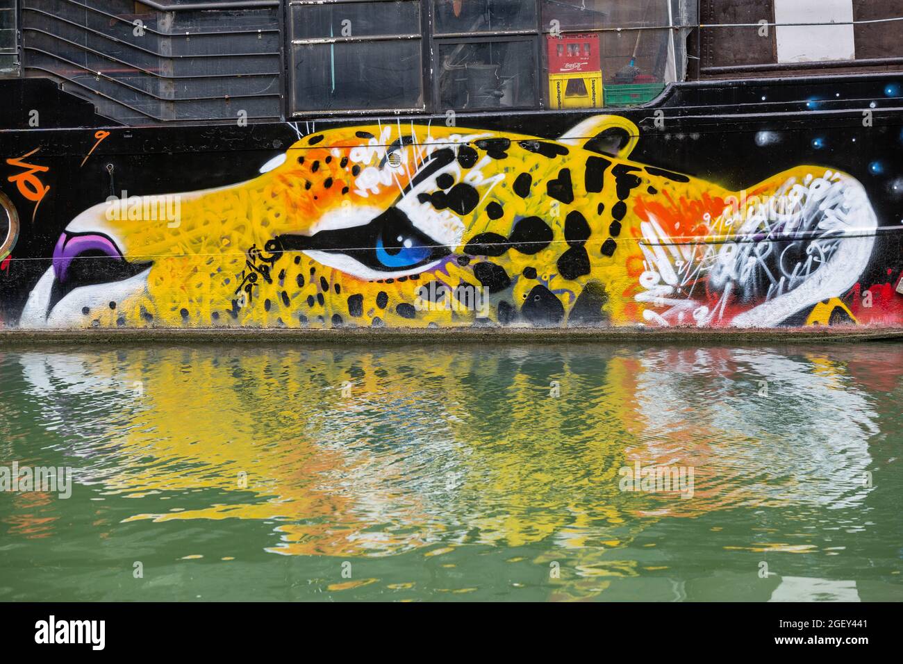 Half-submerged painted cheetah's head on the sides of a barge on the ...