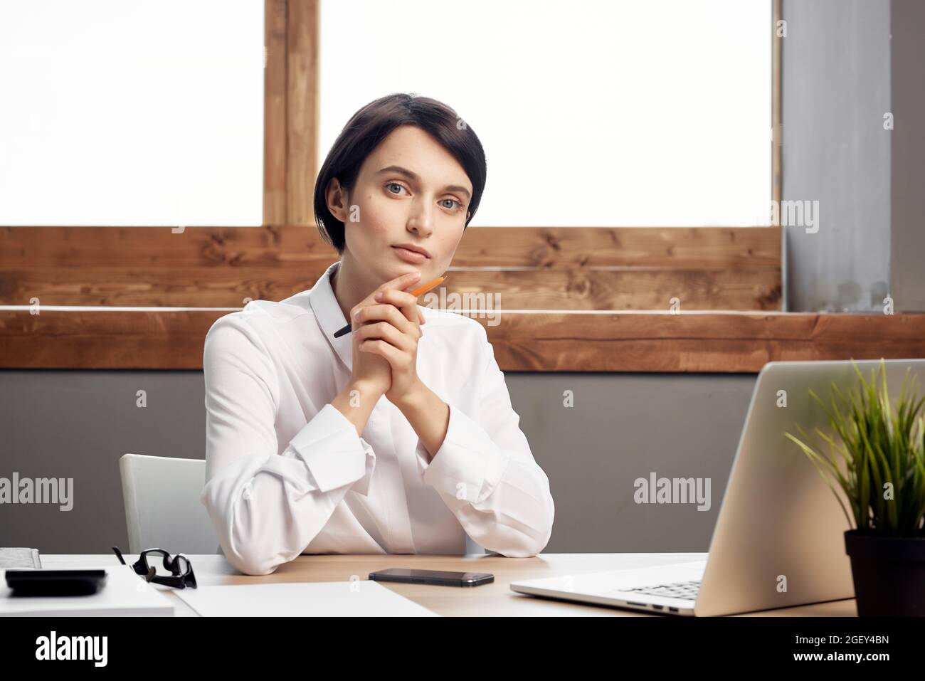 female manager in the office with glasses self-confidence light ...