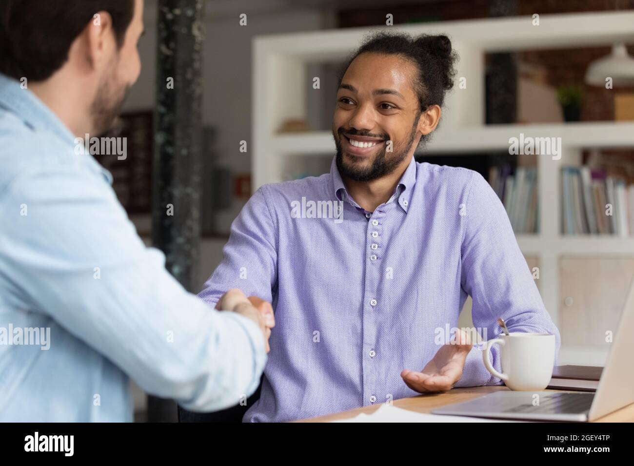 Hired African employee shake hand recruitment completing job interview ...