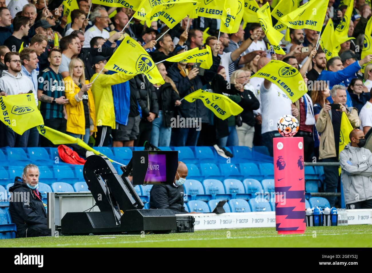 Leeds United fans wave flags before kick off above the VAR screen and ...