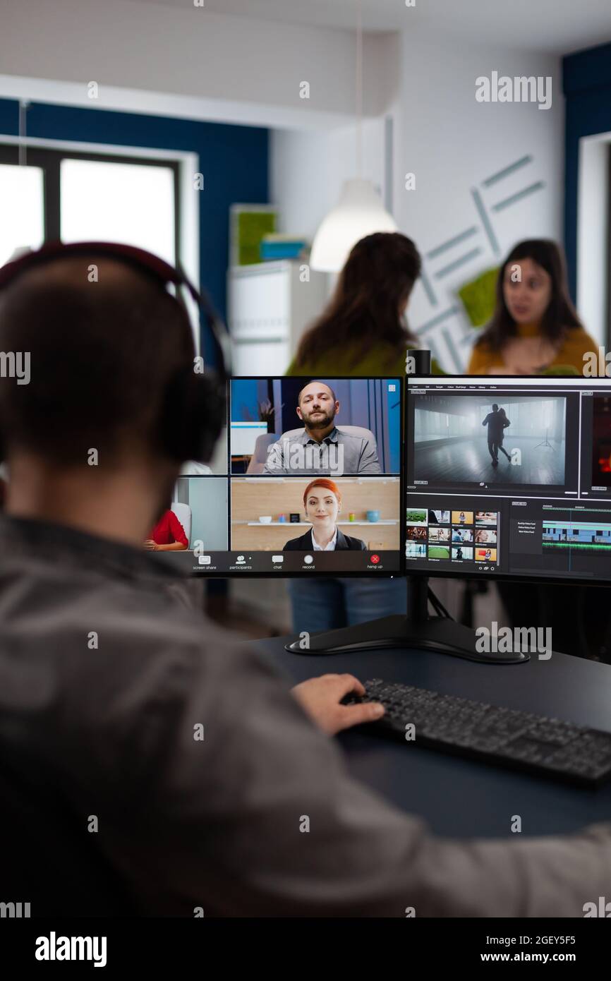 Senior video editor director talking with creative team in web online ...